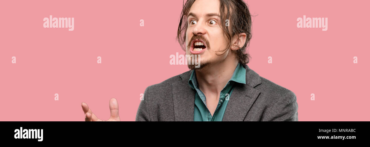 Handsome young man terrified and nervous expressing anxiety and panic ...