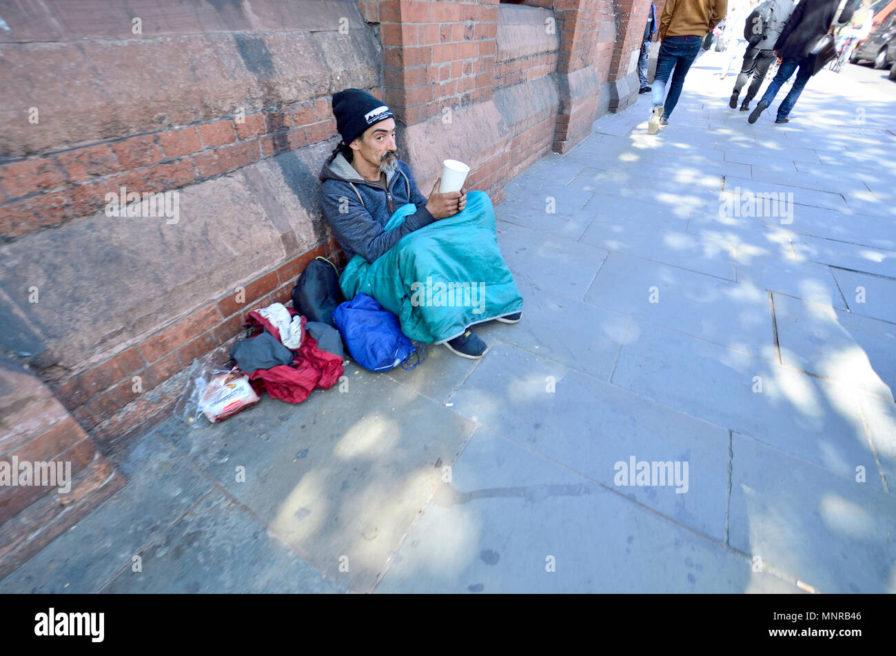 Homeless man begging on the pavement, Kings Cross, London, England, UK ...