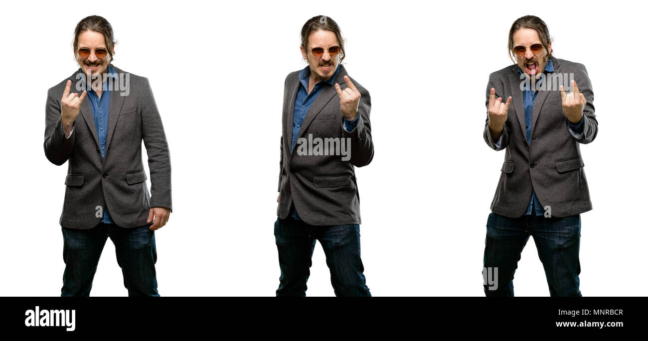 Handsome young man making rock symbol with hands, shouting and ...