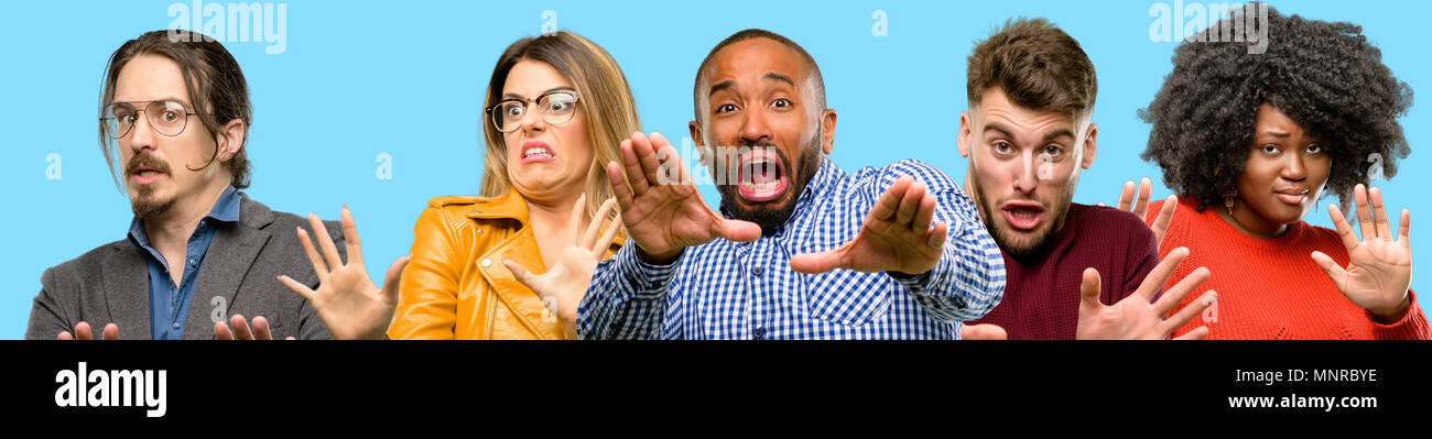 Group of mixed people, women and men disgusted and angry, keeping hands ...