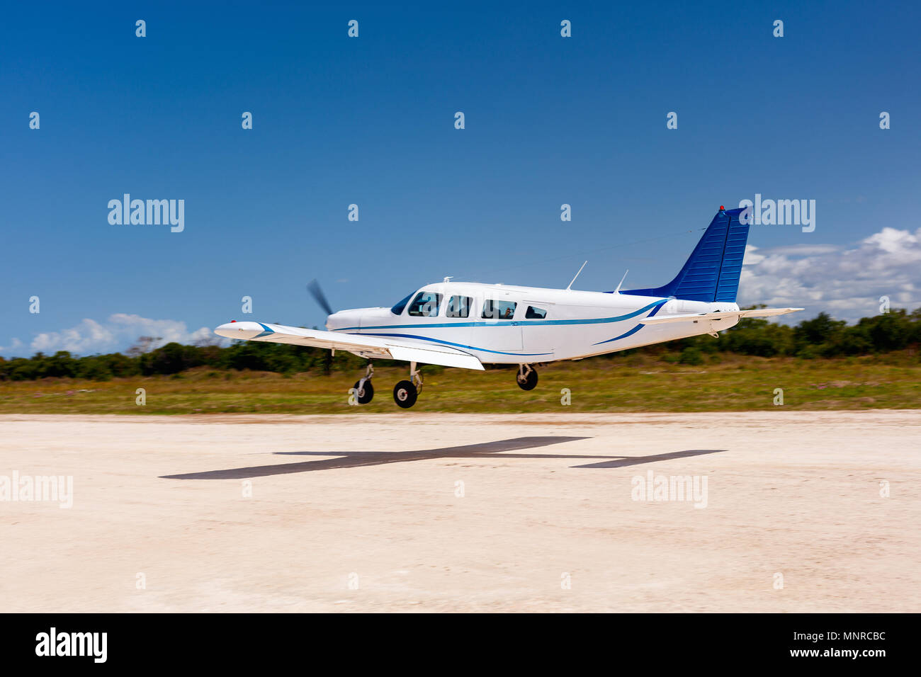 Small airplane is landing at tropical island Stock Photo - Alamy