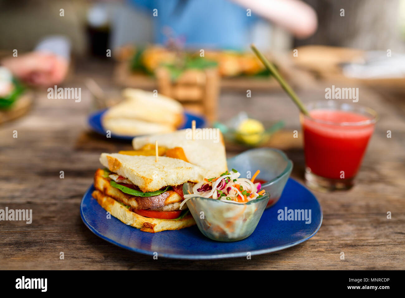 Delicious fresh fish sandwich and green salad served for lunch Stock ...