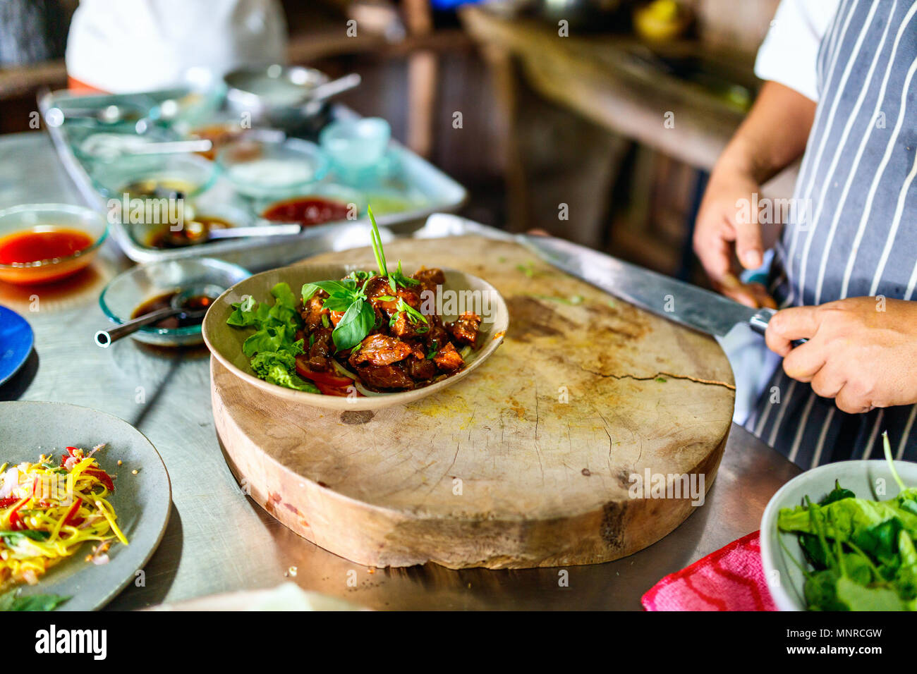 Chef making traditional cambodian meat dish at cooking class Stock ...