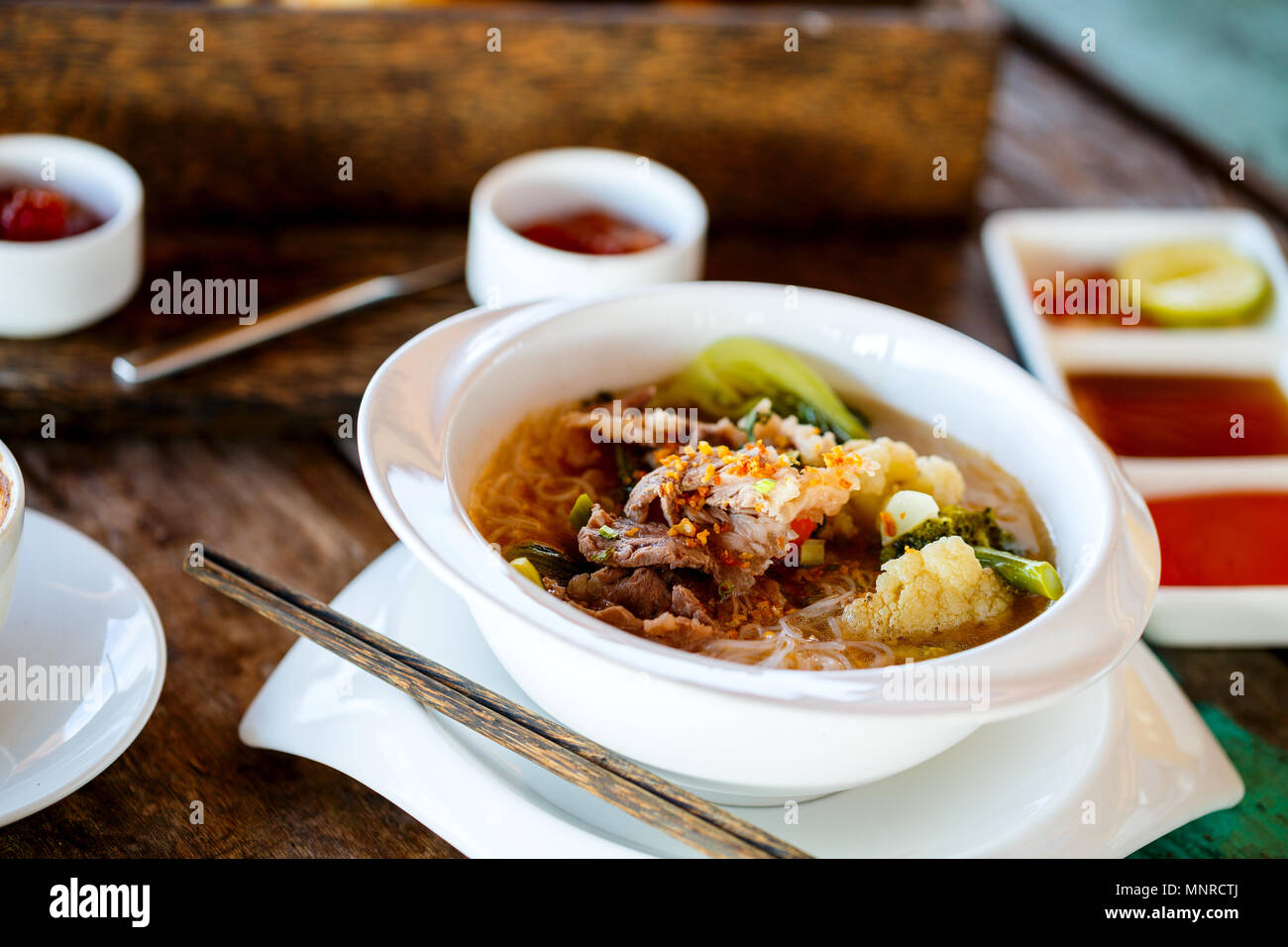 Delicious Asian noodle and meat dish served for breakfast or lunch ...