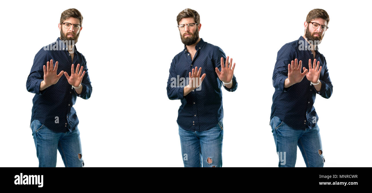 Young man with beard annoyed with bad attitude making stop sign with ...