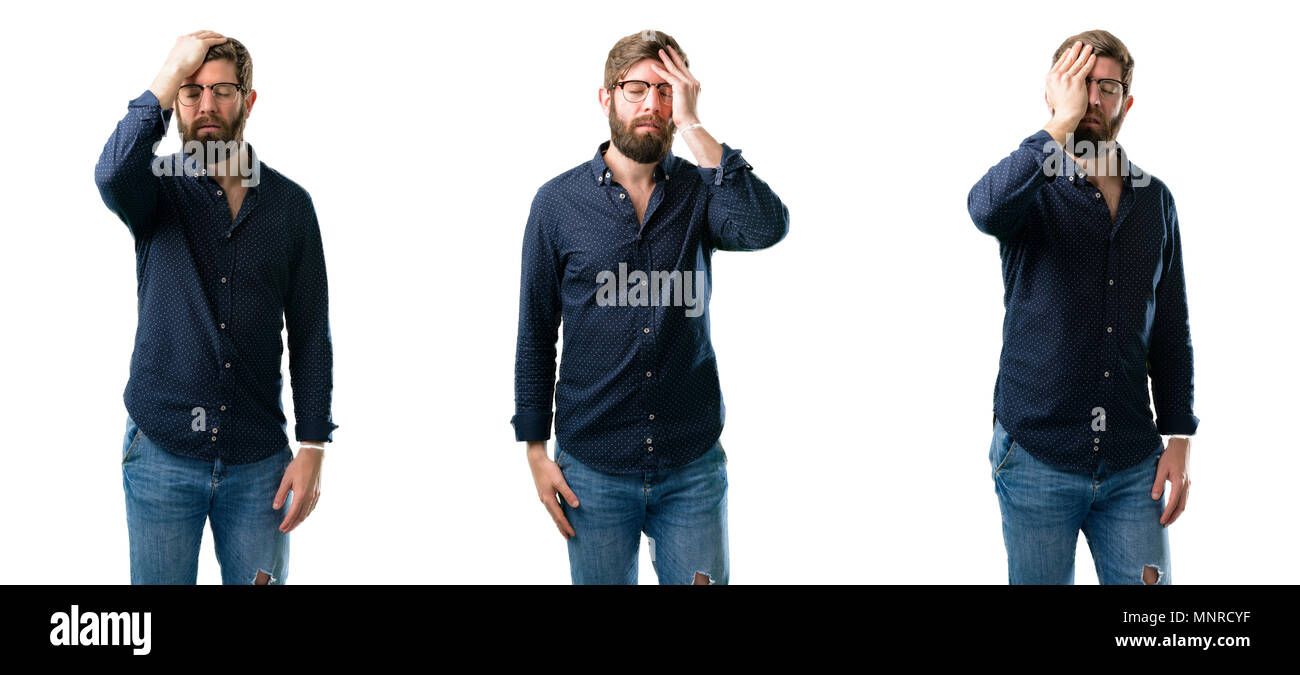 Young man with beard stressful keeping hand on head, tired and ...