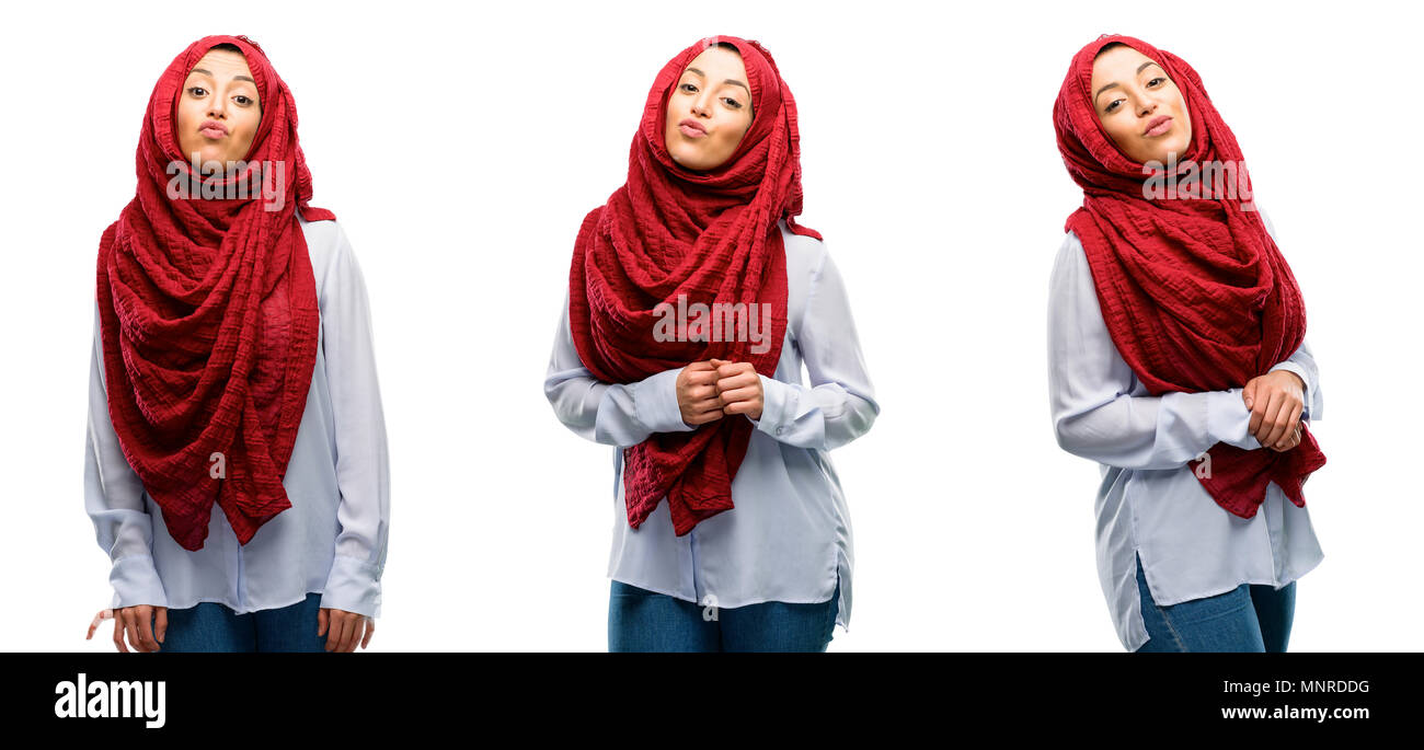 Arab woman wearing hijab expressing love, blows kiss at camera ...