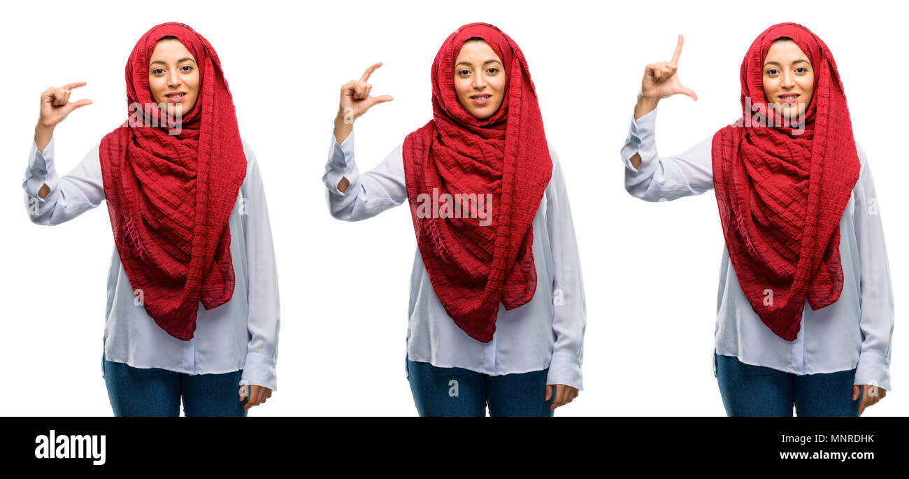 Arab woman wearing hijab holding something very tiny, size concept ...