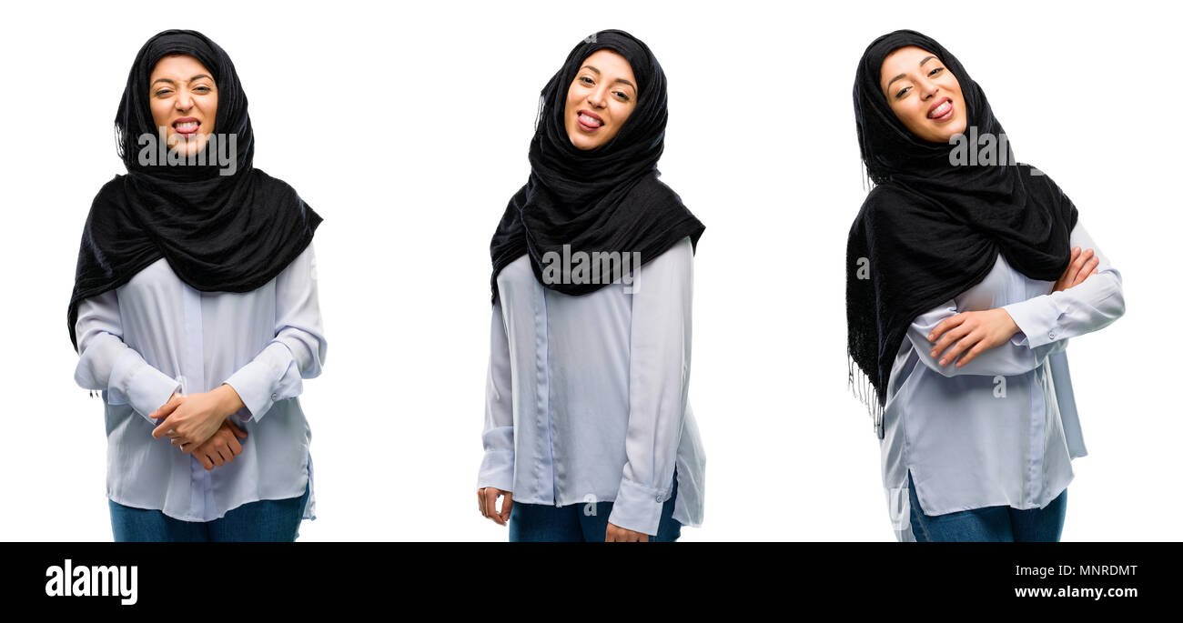 Arab woman wearing hijab sticking out tongue at camera at sign of ...