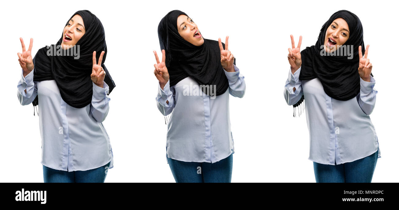 Arab woman wearing hijab happy and excited expressing winning gesture ...