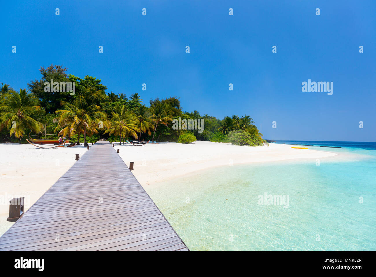 Wooden pathway leading to beautiful tropical island Stock Photo - Alamy