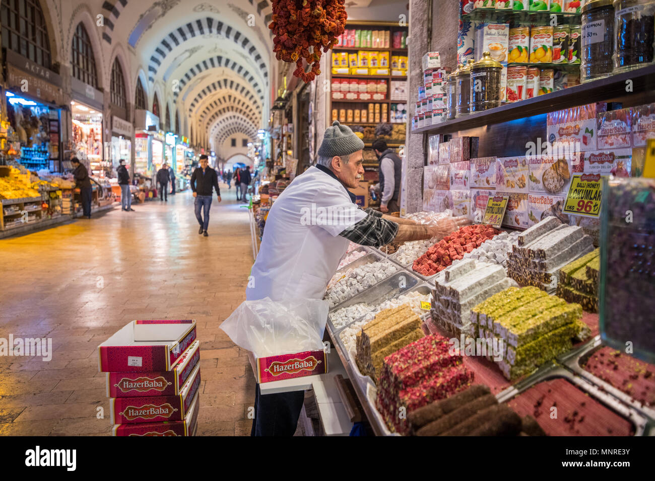 Male merchant organizing the display of Turkish delights at this market ...