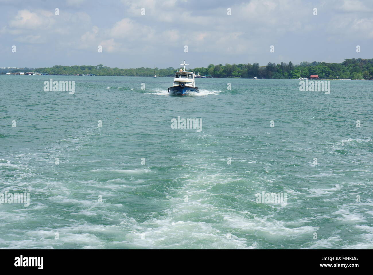 A Bum-boat captured sailing in middle of sea Stock Photo - Alamy