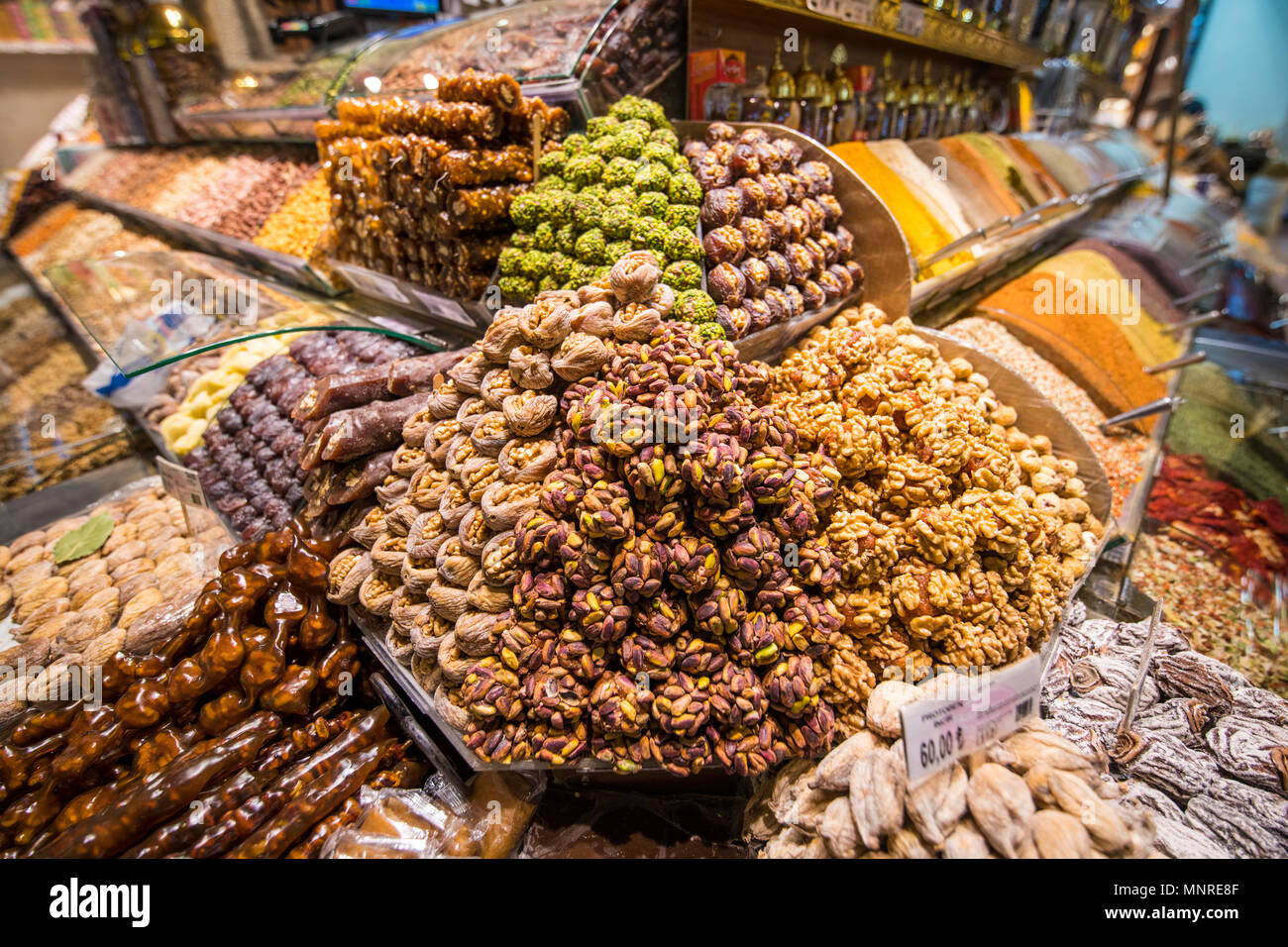 Corner of a market stall displays an assortment of sweets, spices and ...