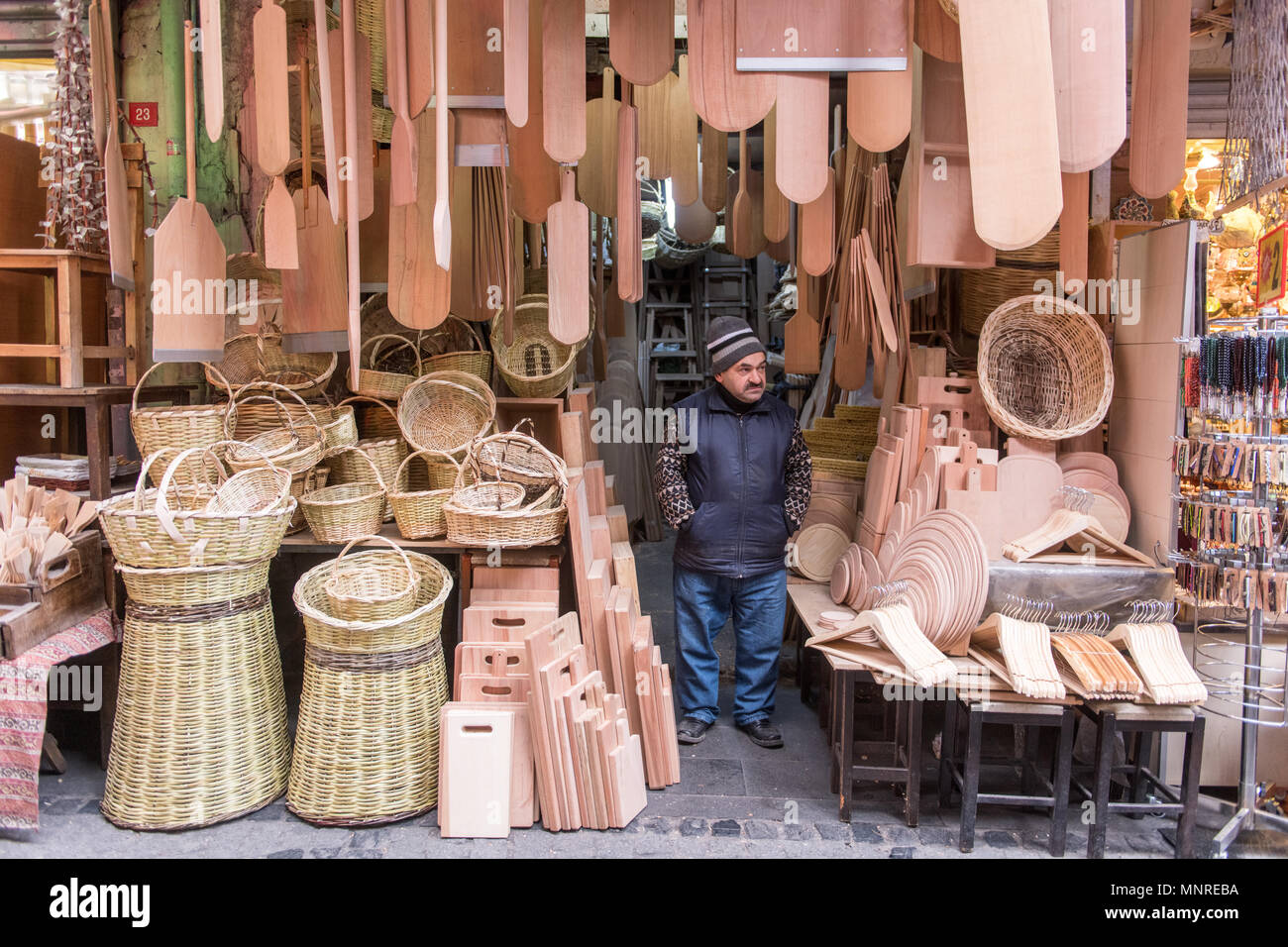 Adult male merchant stands with his hands in his pockets in entryway to ...