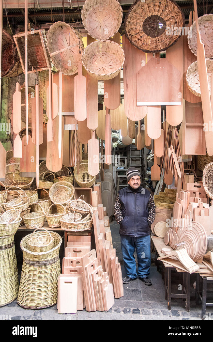 Adult male merchant stands with his hands in his pockets in entryway to ...