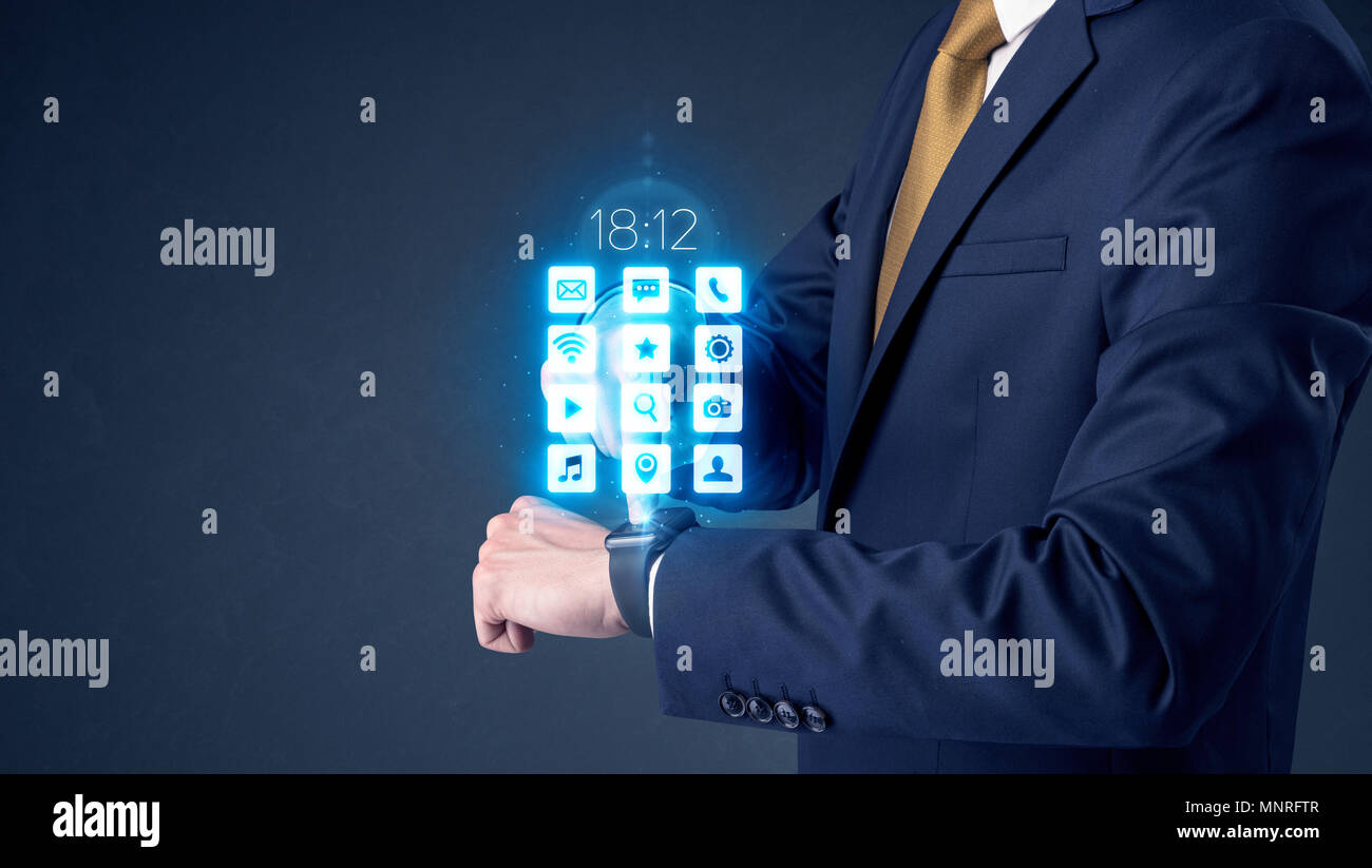 Businessman wearing smartwatch with application icons Stock Photo - Alamy