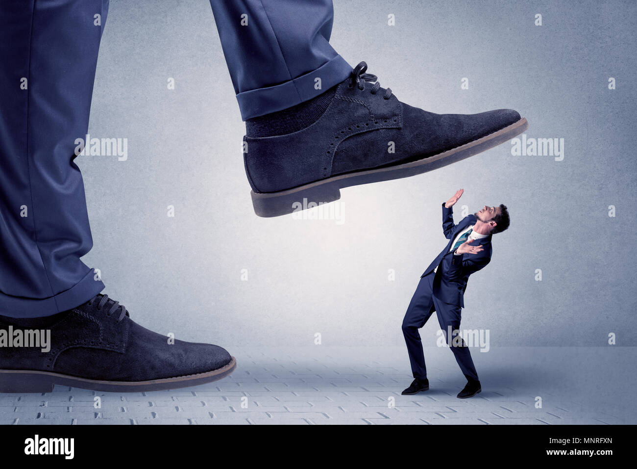 Young handsome businessman getting crushed by a big formal shoe Stock ...