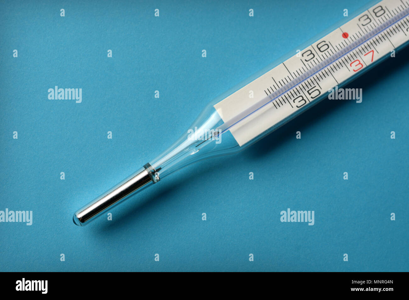 thermometer to measure body temperature on the blue background ...