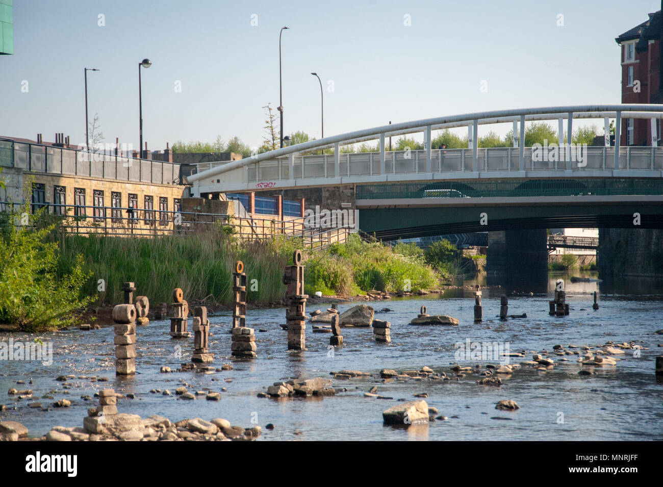 Stone sculptures rise from the River Don beneath the Wicker bridge in ...
