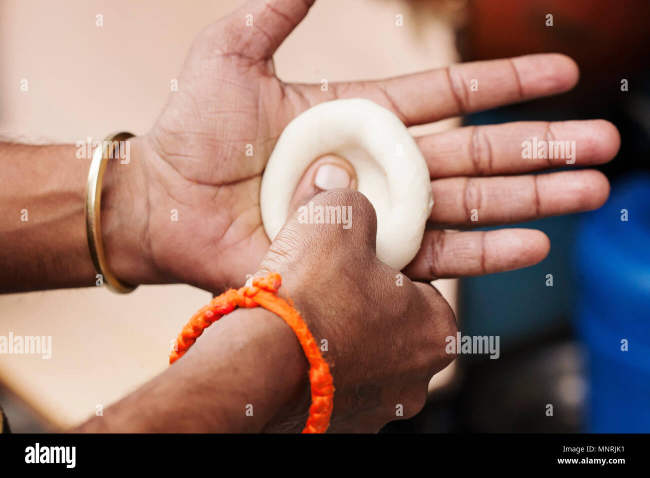 Indian male hands preparing Katchuri - traditional Indian fried food ...