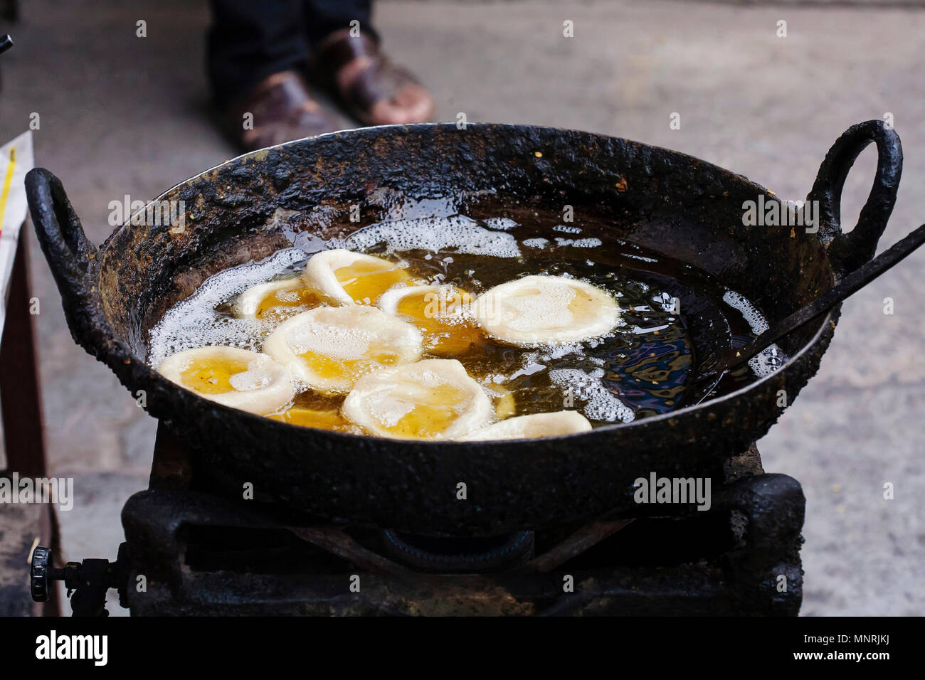 Big pan with Katchuri in boiling oil - traditional Indian fried food ...