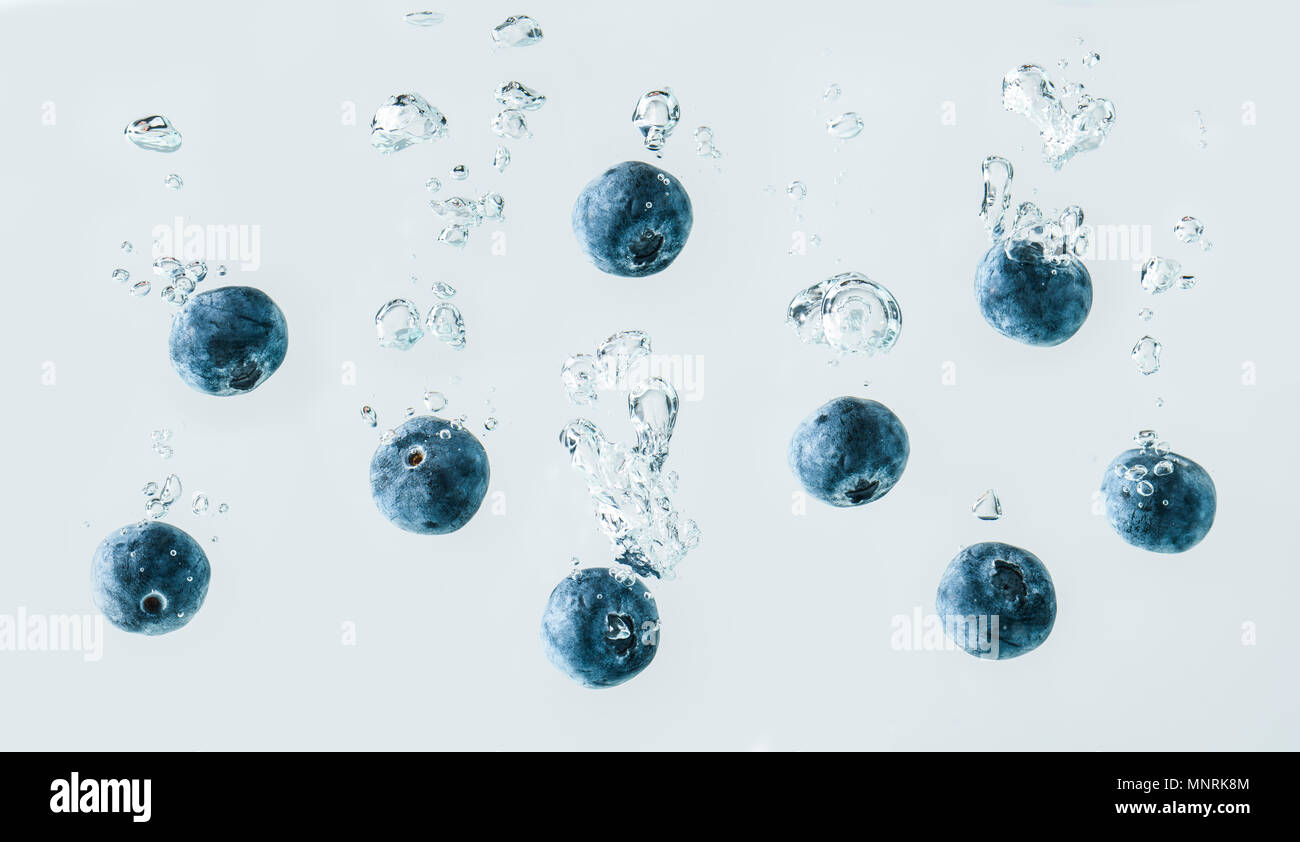 Blueberries sinking into water with air bubbles background Stock Photo ...