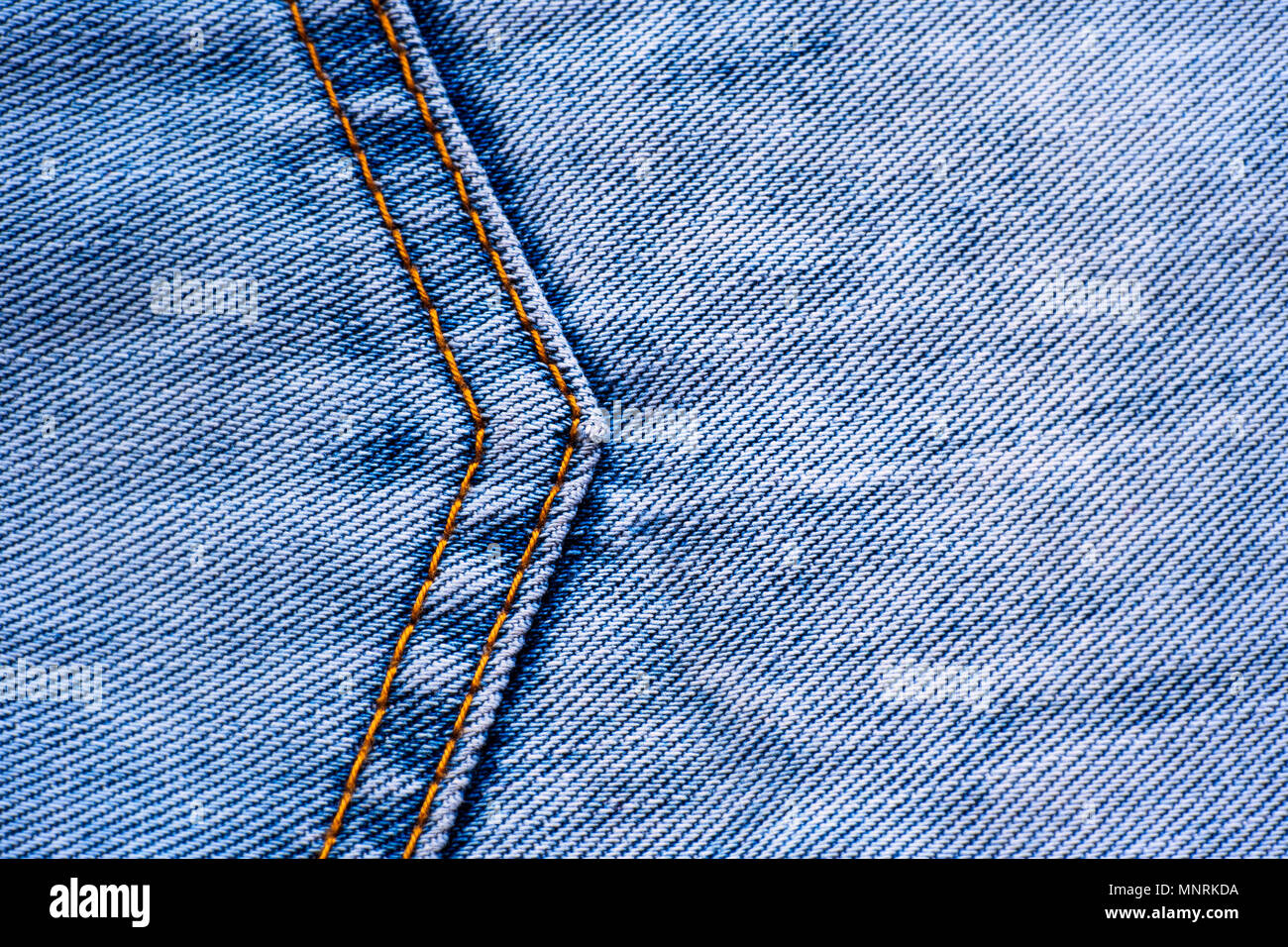 a large seam in the form of an arrow on a denim blue fabric Stock Photo ...