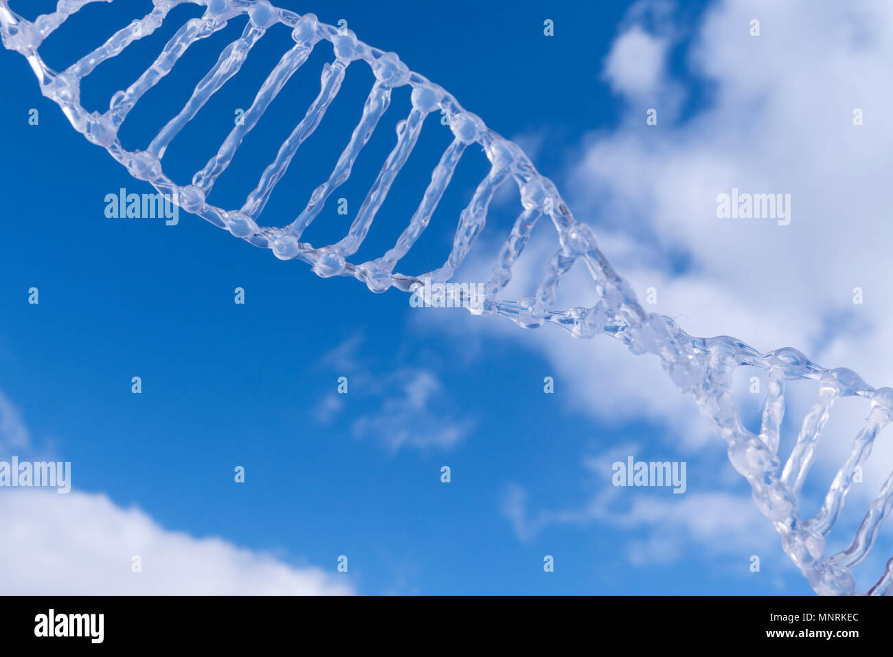 spiral dna against the blue sky with clouds Stock Photo - Alamy