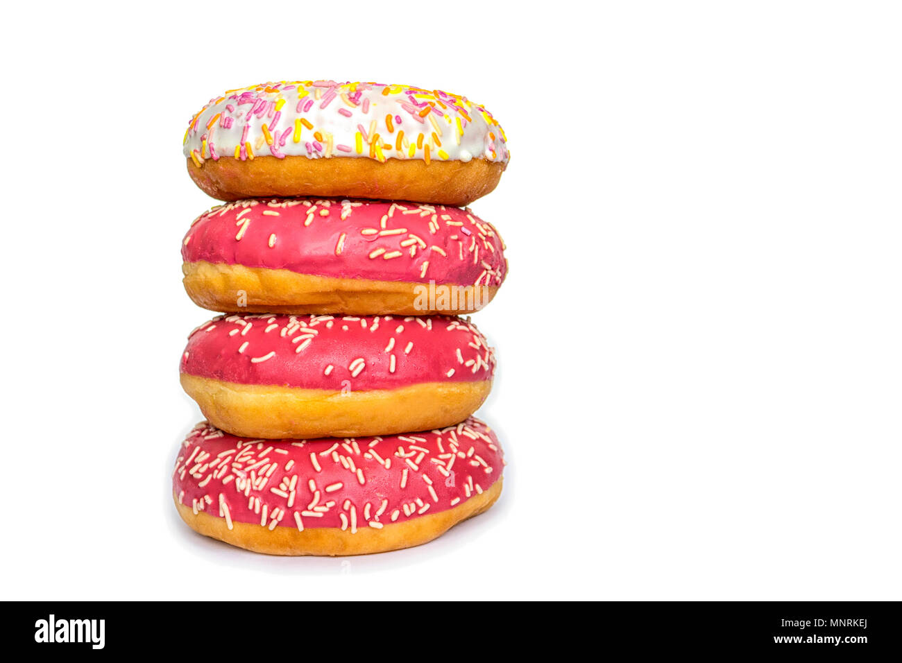 four donuts with a pink icing on a white background Stock Photo - Alamy