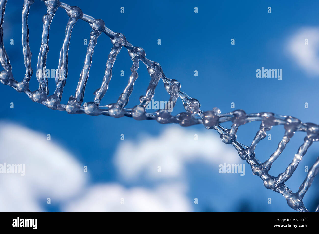 spiral dna against the blue sky with clouds Stock Photo - Alamy