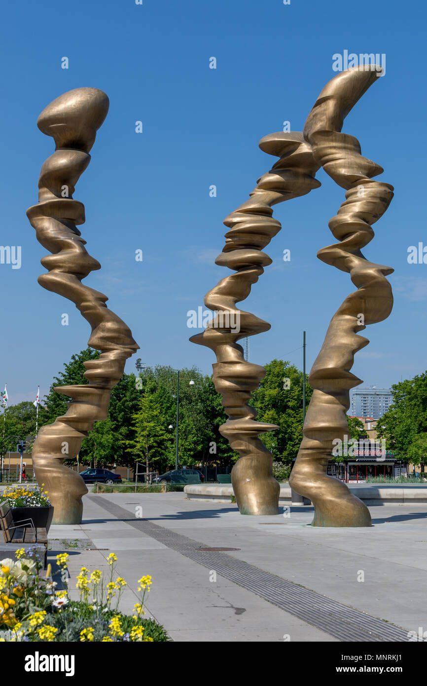 Three tall gold abstract sculptures about two storeys high Stock Photo ...