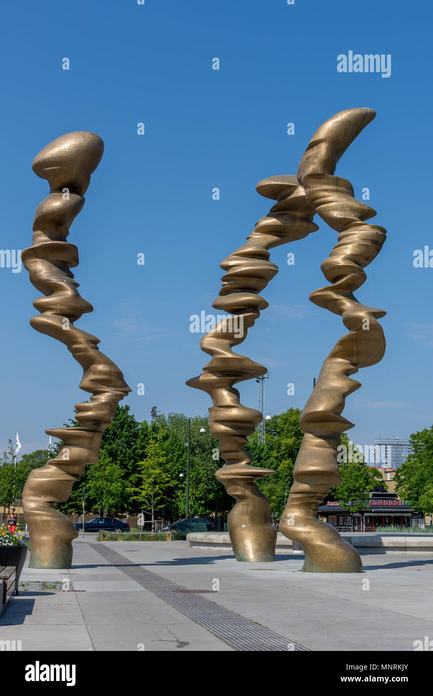 Three tall gold abstract sculptures about two storeys high Stock Photo ...