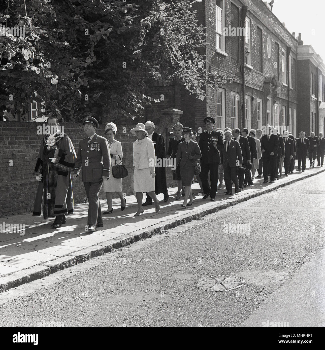 1965, historical, the lcoal major, military and other people walking ...
