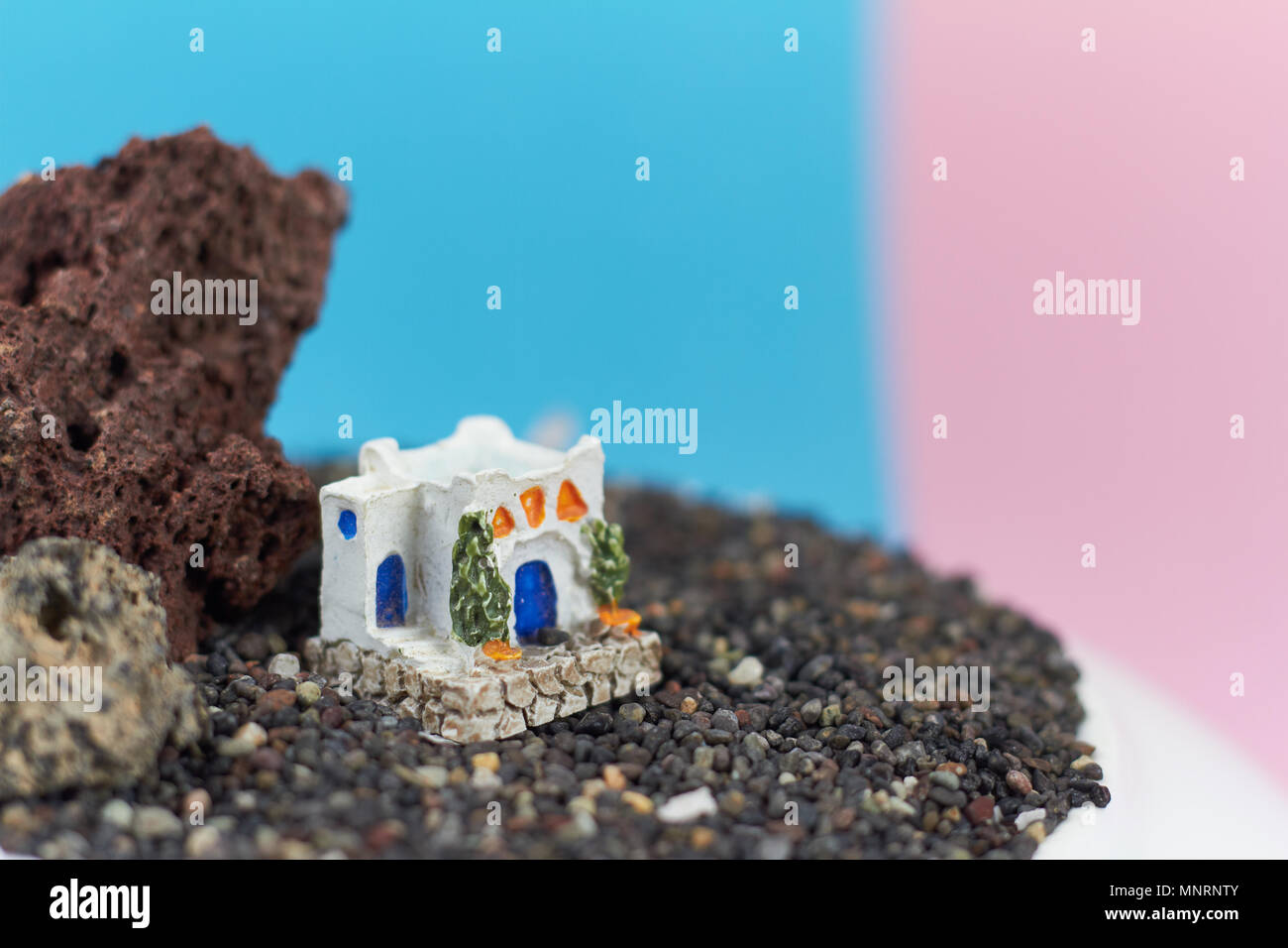 Animated model of a Greek house on a rock on a neon and pink background ...