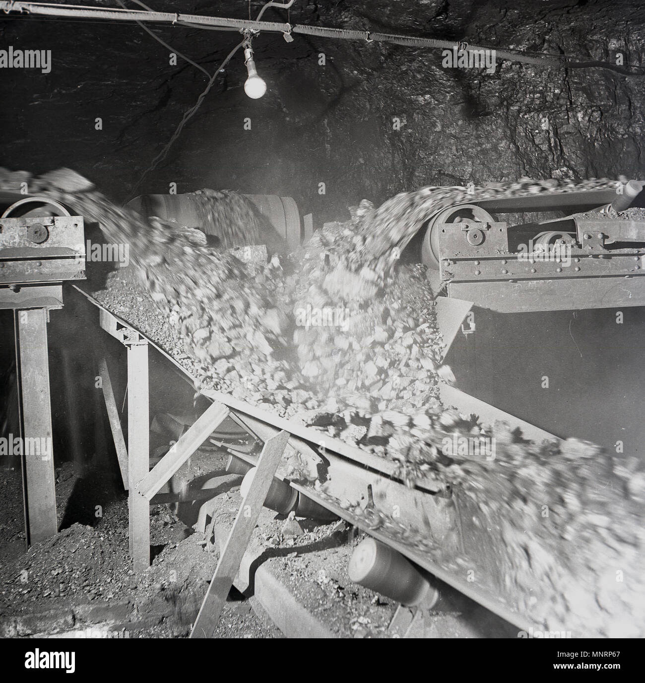 1950s, historical, freshly dug coal being carried or transported ...