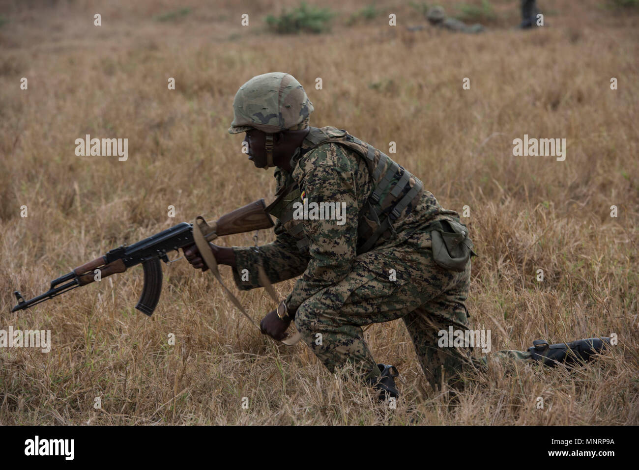 Uganda Peoples' Defence Force soldiers practice ground maneuvers during ...