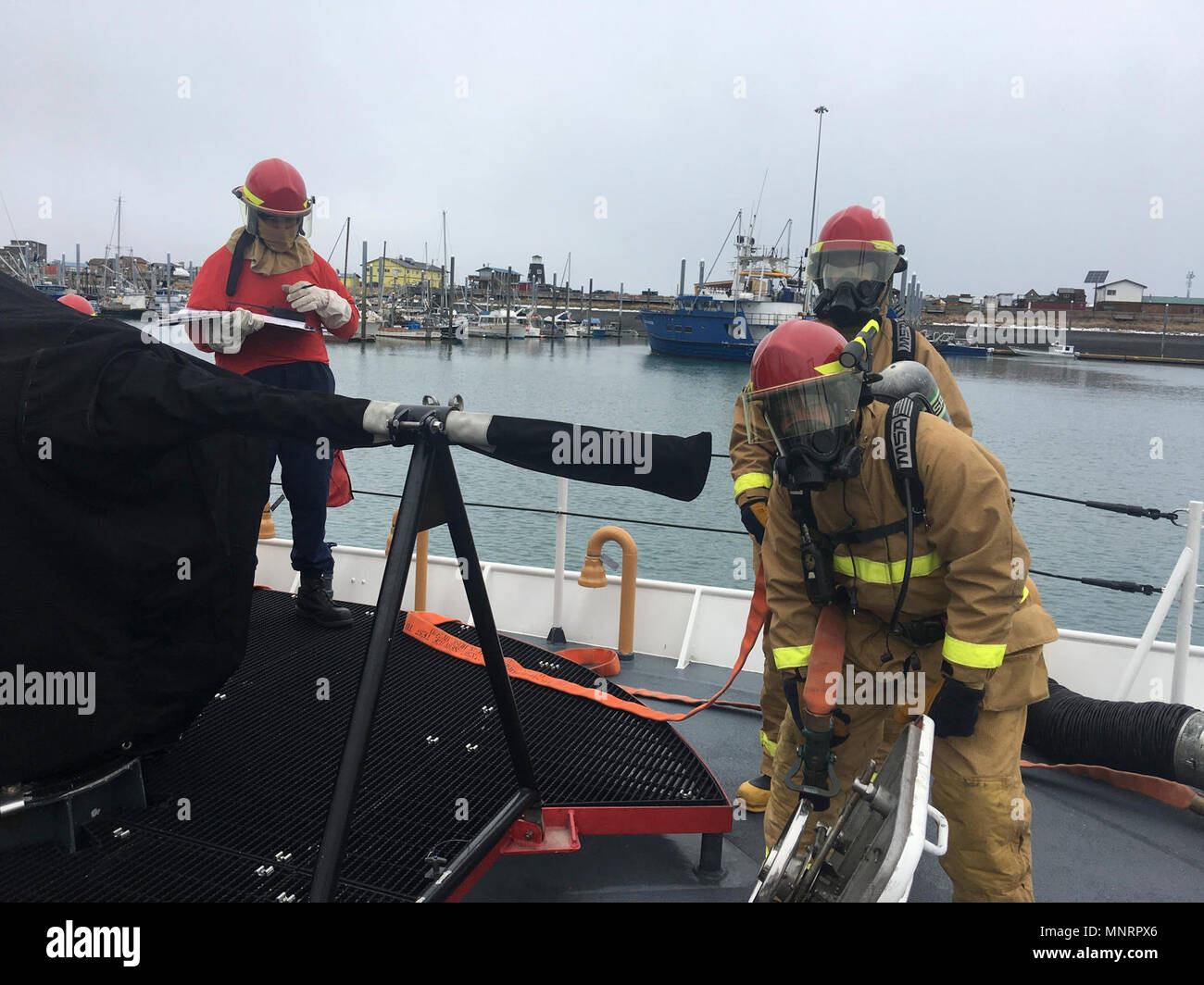 Coast Guard Cutter Naushon (WPB 1311) crew members conduct firefighting ...