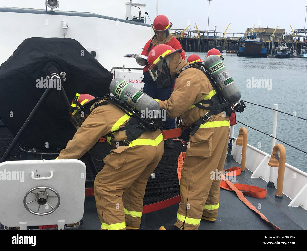 Coast Guard Cutter Naushon (WPB 1311) crew members conduct firefighting ...