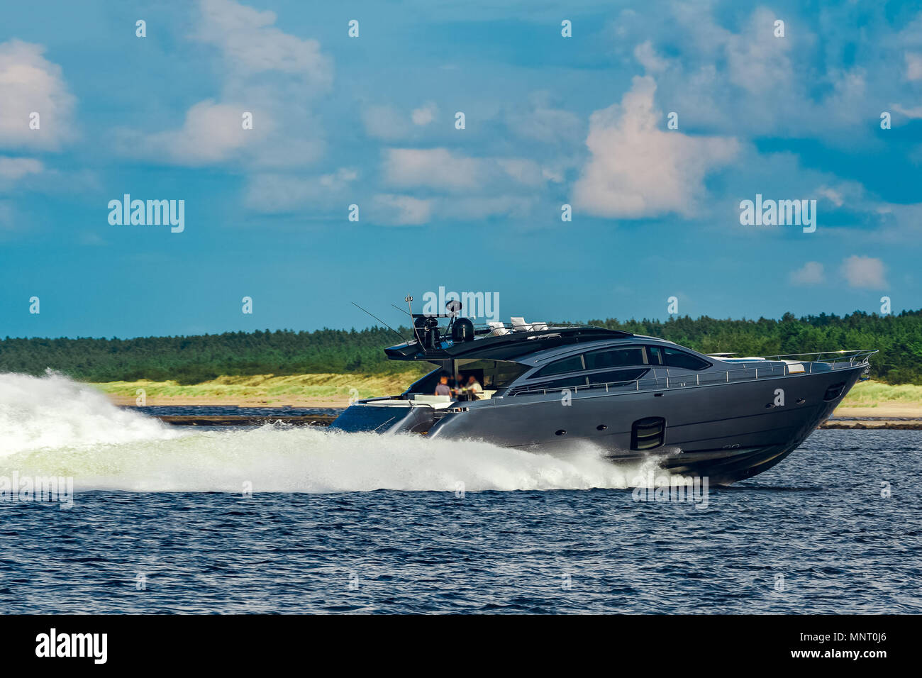 Grey speedboat moving fast by the river in Latvia. Water sport Stock ...