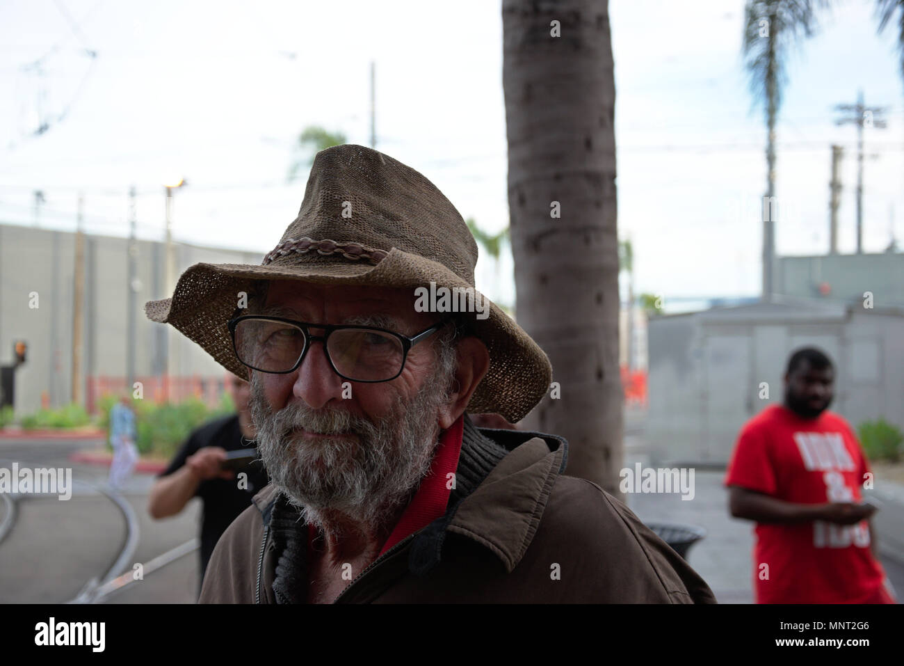 Homeless with beard glasses and hat on Stock Photo - Alamy