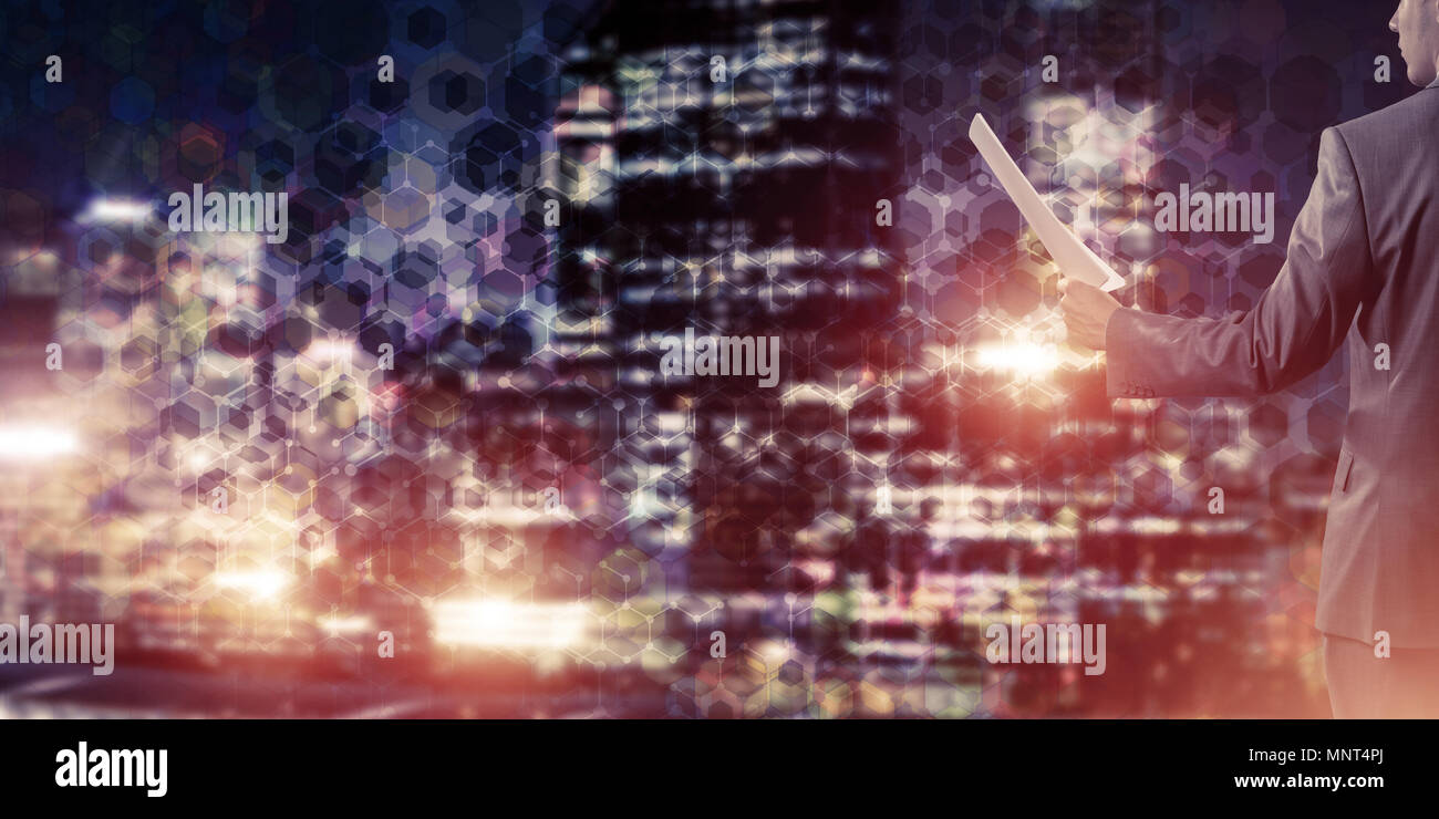 Rear view of businessman against night cityscape background and Stock ...