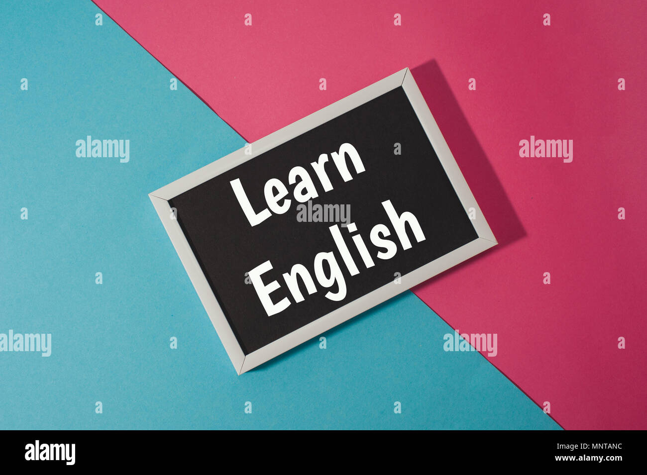 Learn English - text on chalkboard on blue and pink bright background ...