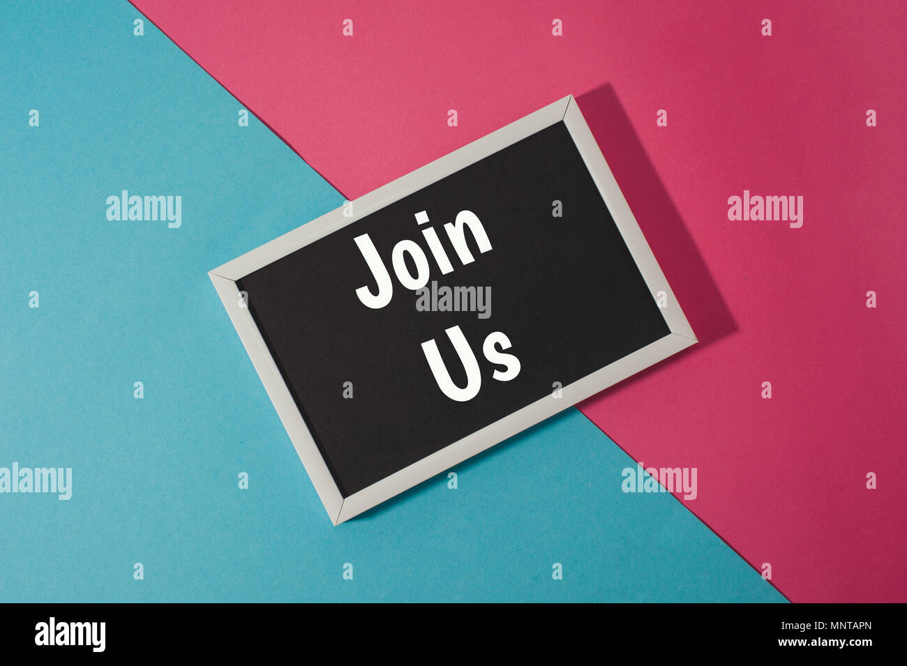 Join us - text on chalkboard on blue and pink bright background Stock ...