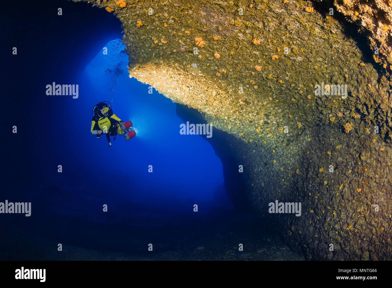 woman scuba diver, exploring Billinghurst Cave, Gozo, Malta ...