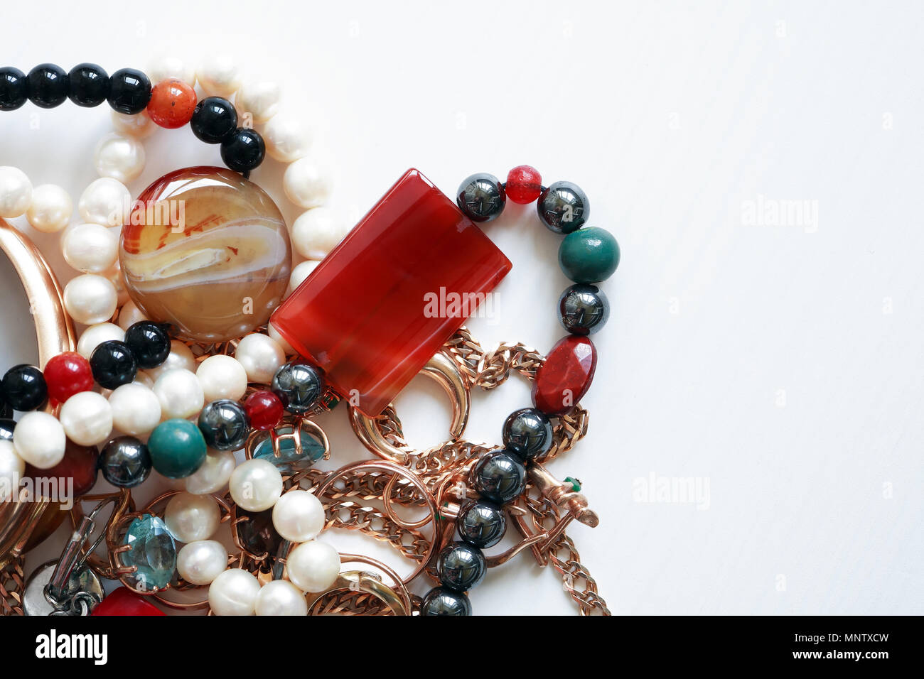 Set of various jewelry adornments on white background with free space ...