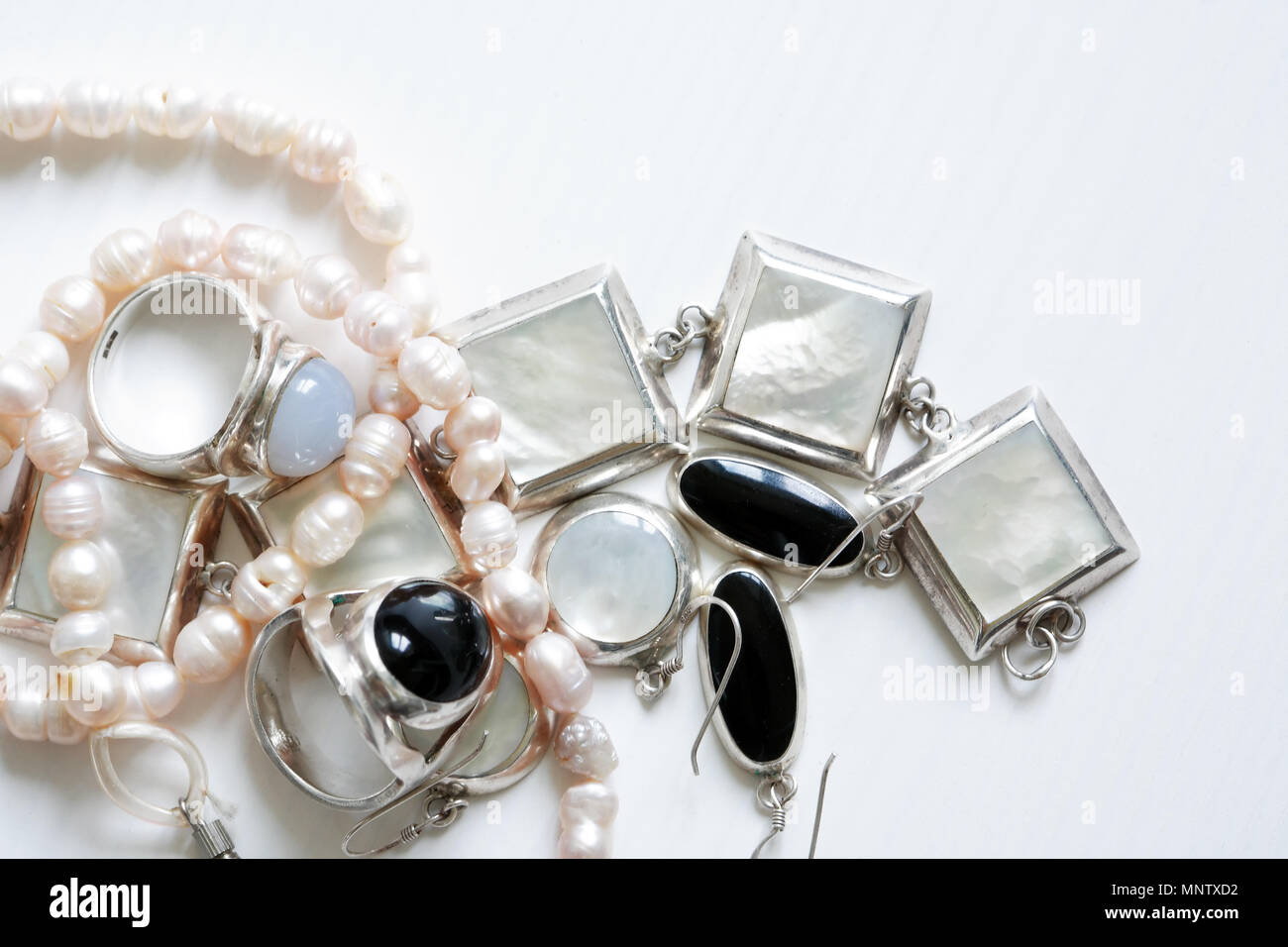 Set of various jewelry adornments on white background with free space ...