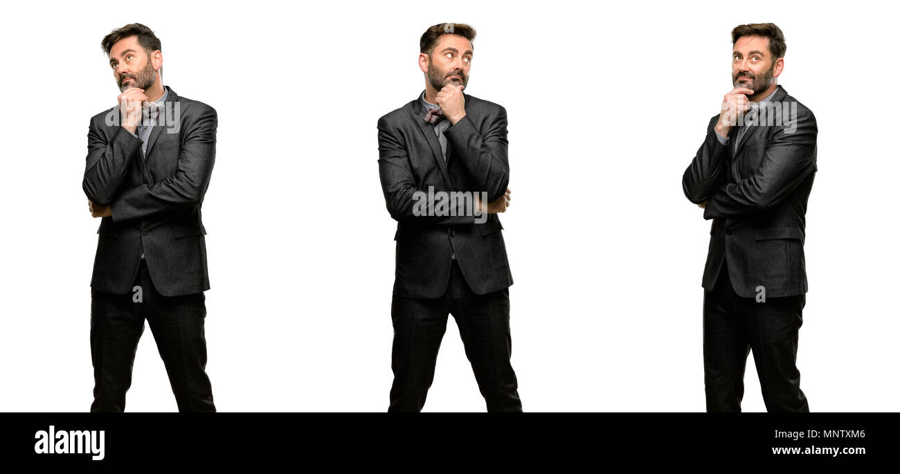 Middle age man, with beard and bow tie thinking and looking up ...
