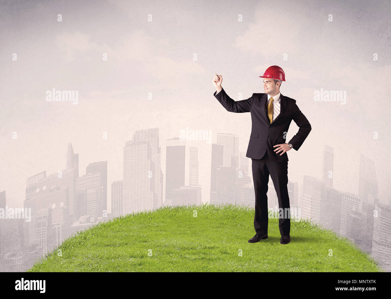 A confident male well looking office manager standing in small green ...