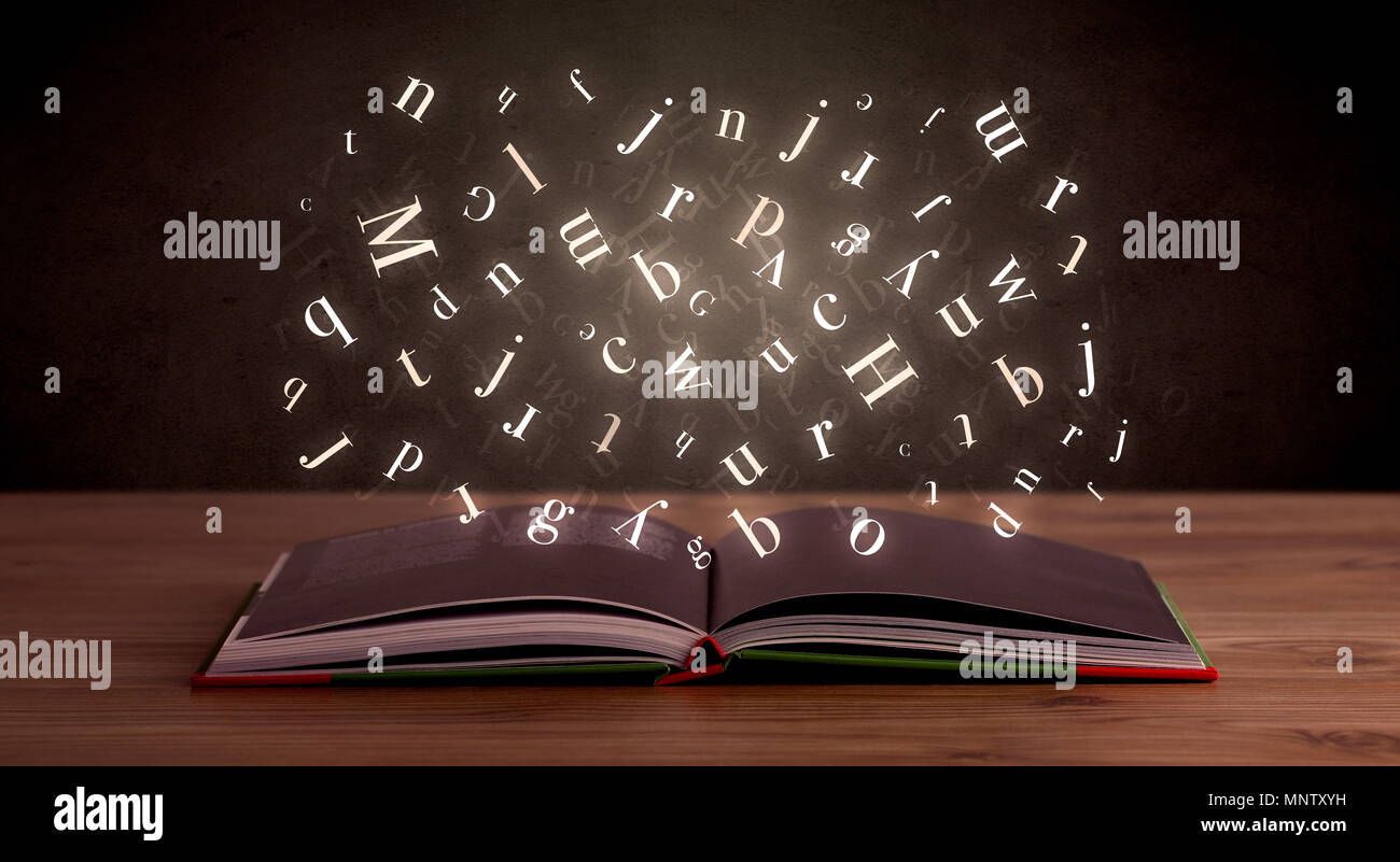 Glowing white alphabet letters coming out of an open book Stock Photo ...
